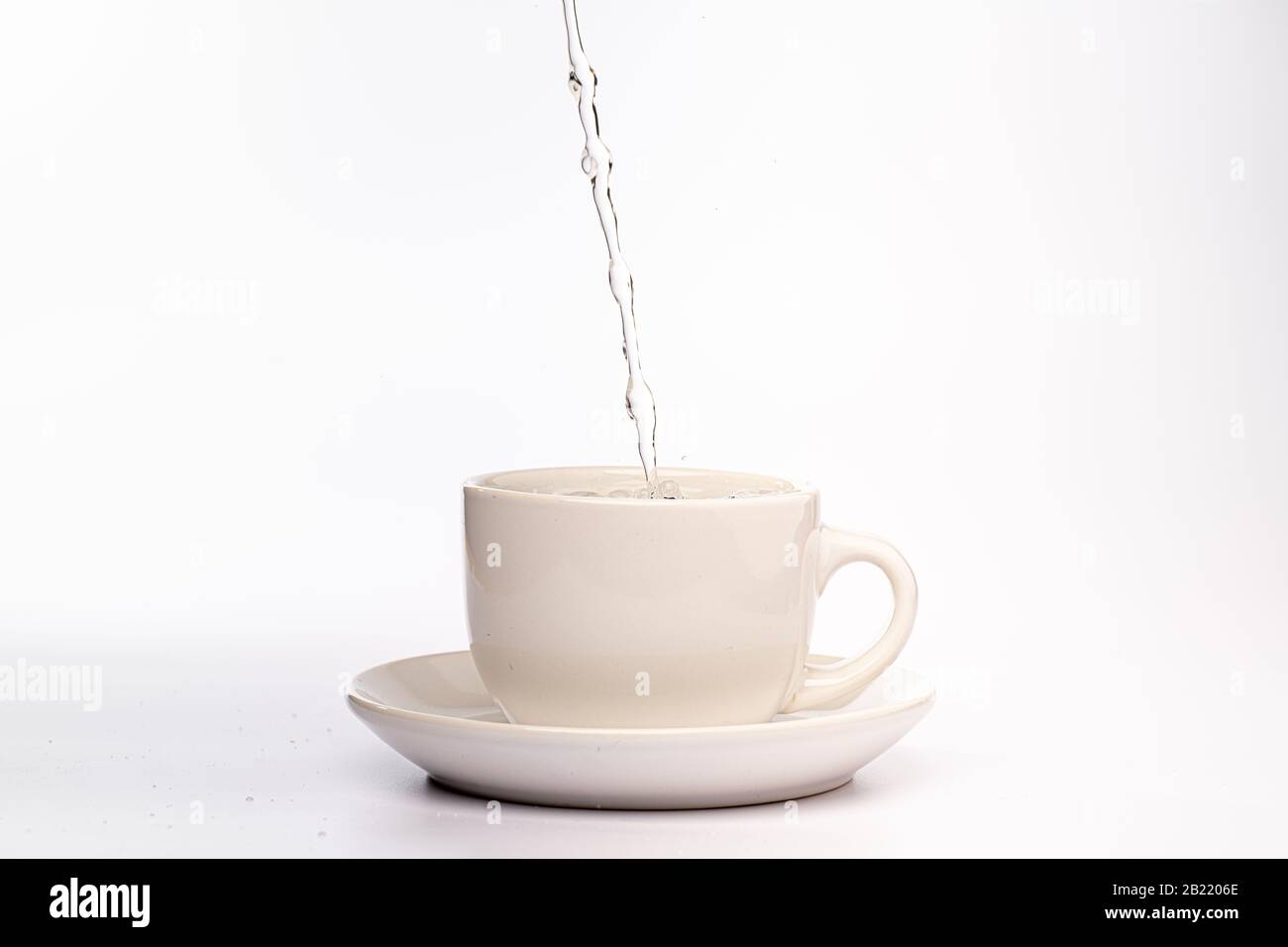 High speed studio photograph of water pouring and splashing into a ...