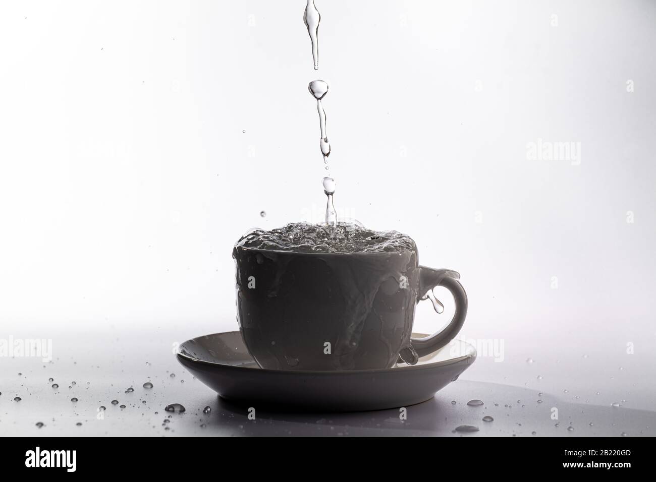 High speed studio photograph of water pouring and splashing into a ...