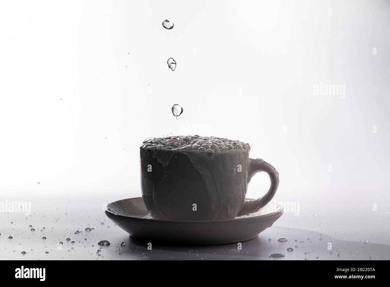 High speed studio photograph of water pouring and splashing into a ...