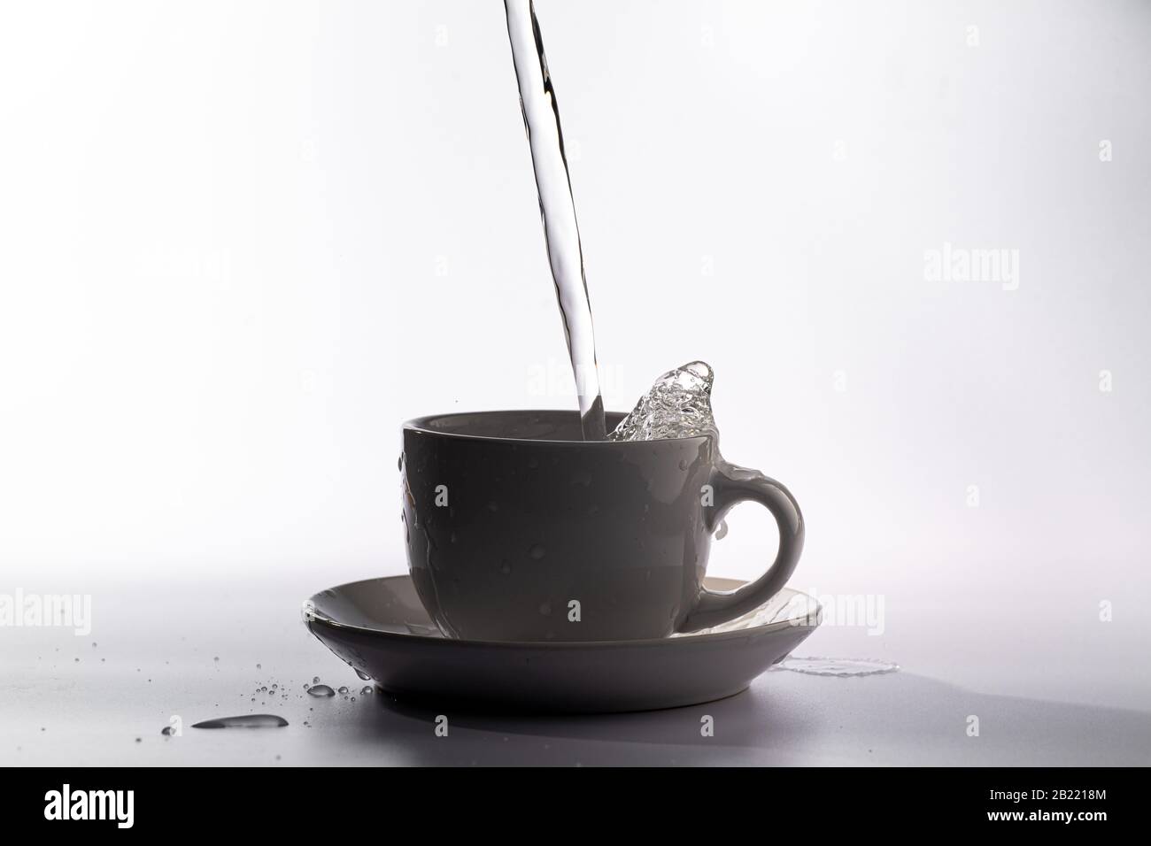 High speed studio photograph of water pouring and splashing into a ...