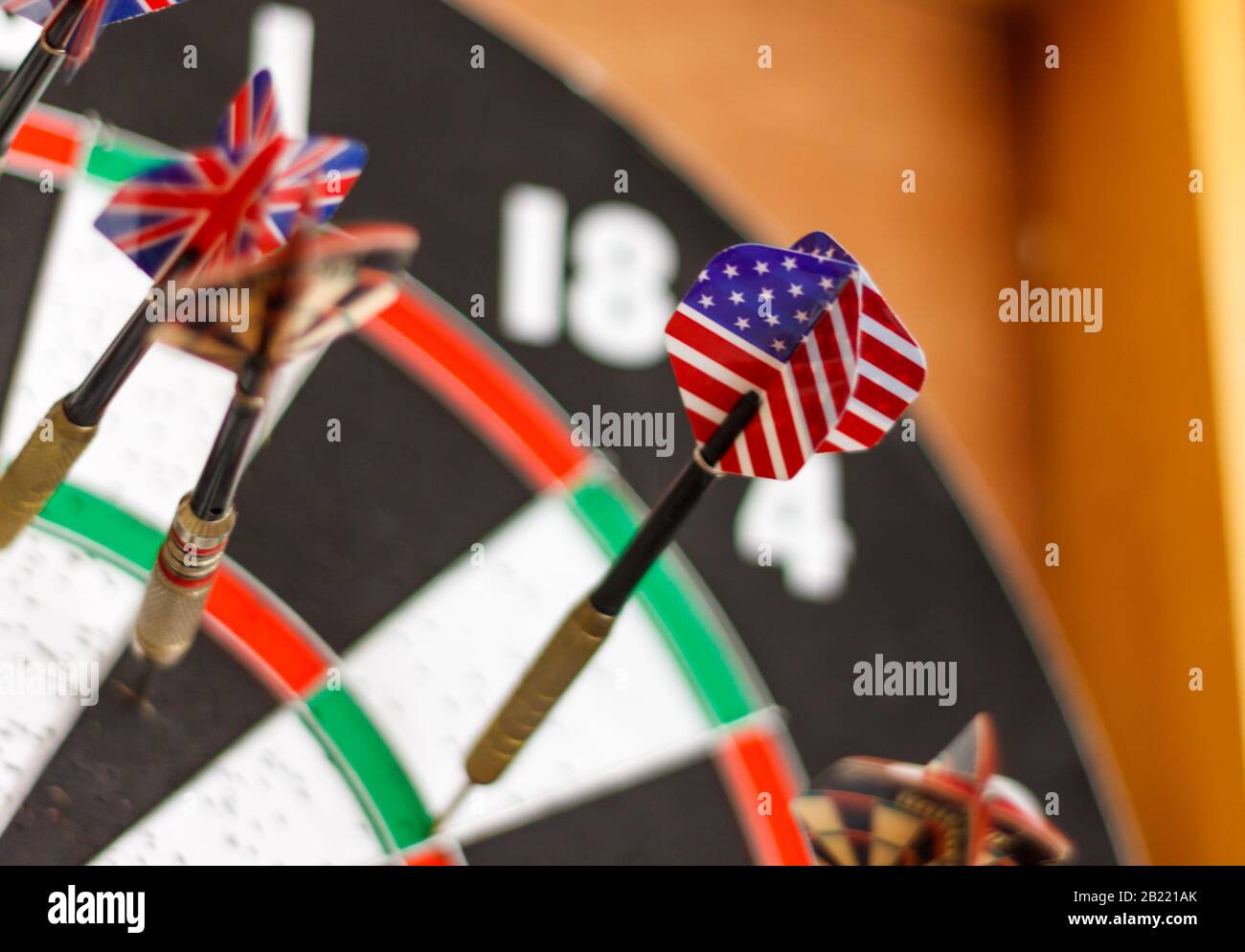 dart board with darts. A close-up image of a dart with feathers in the ...