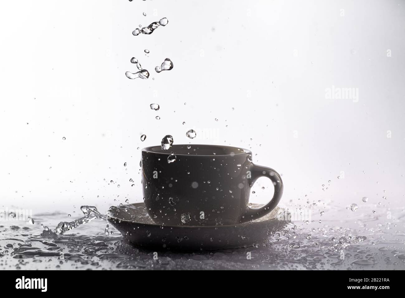 High speed studio photograph of water pouring and splashing into a ...