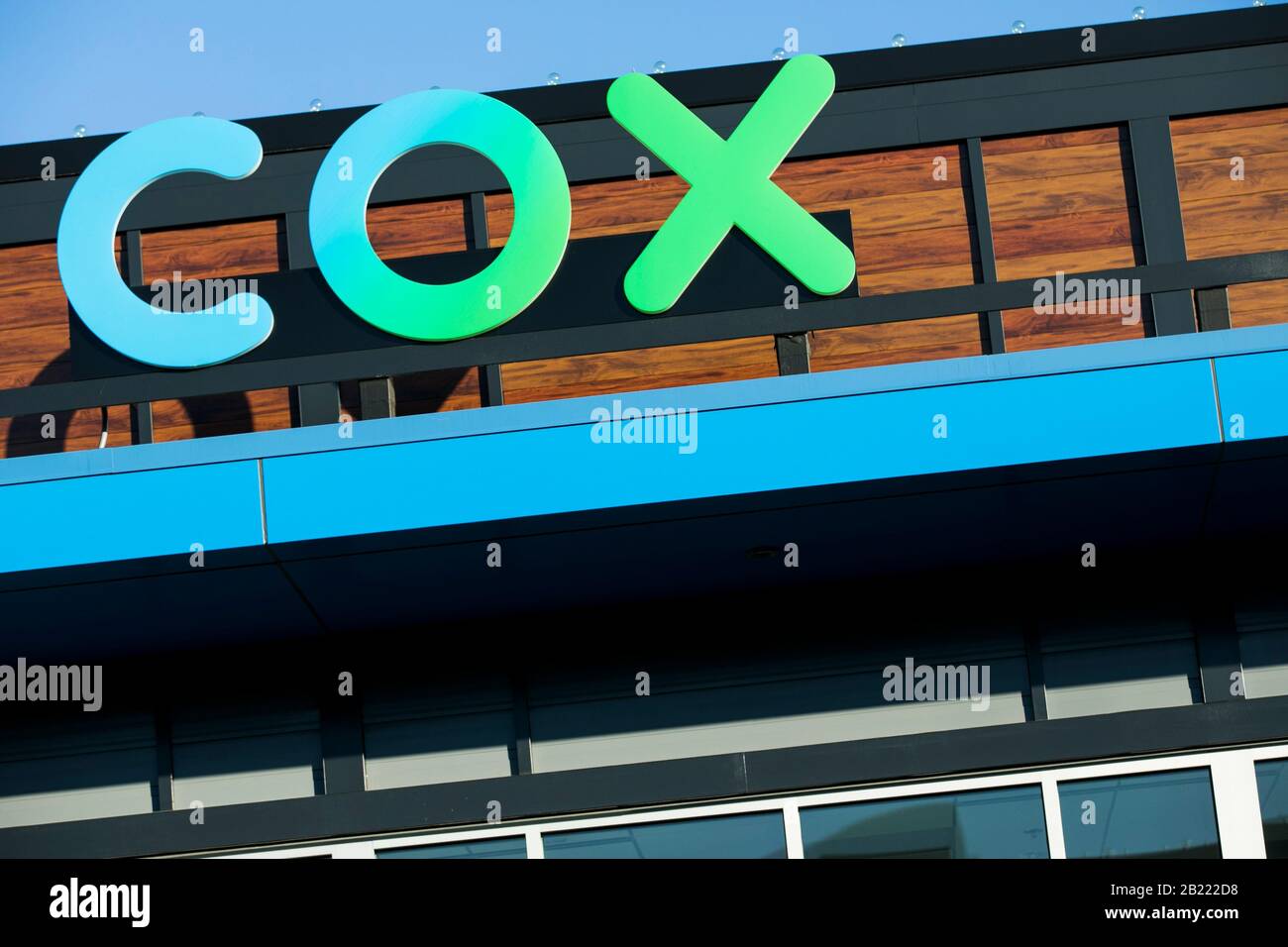 A logo sign outside of a Cox Communications retail store location in ...