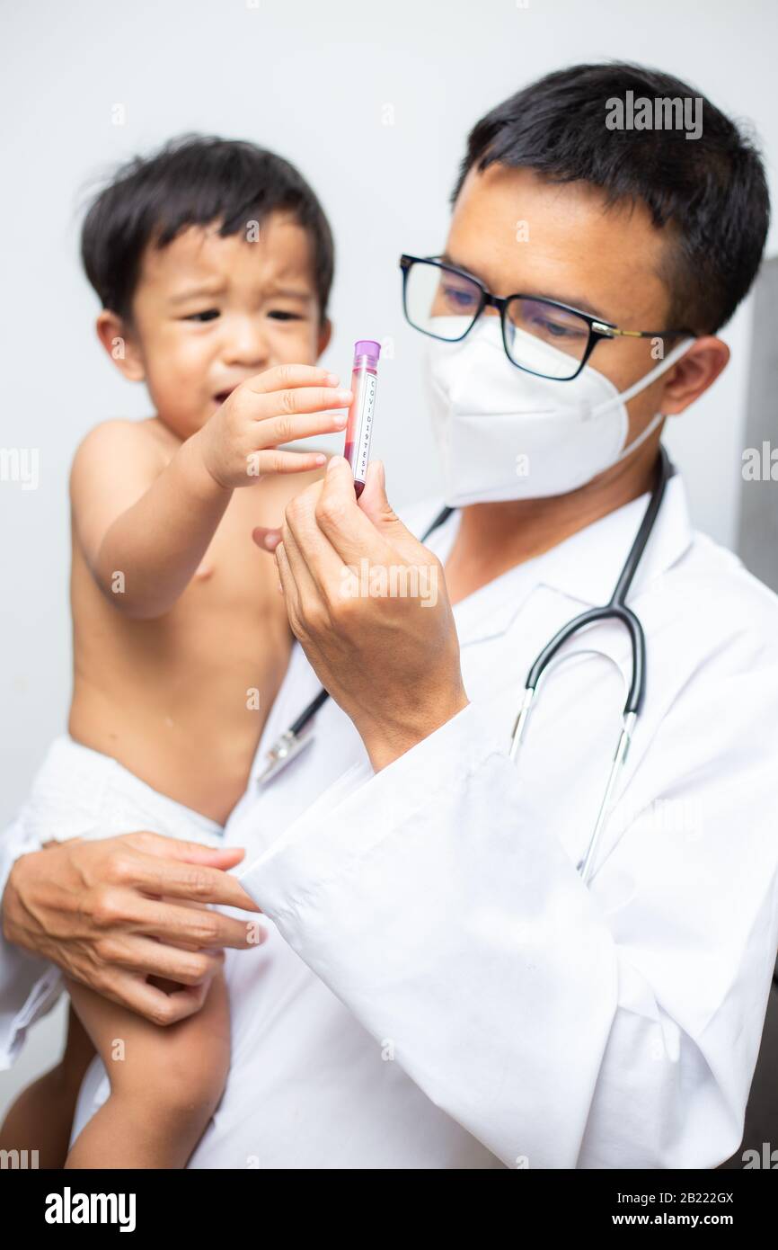 Doctor holding asian baby boy with Coronavirus (COVID-19) Blood in ...