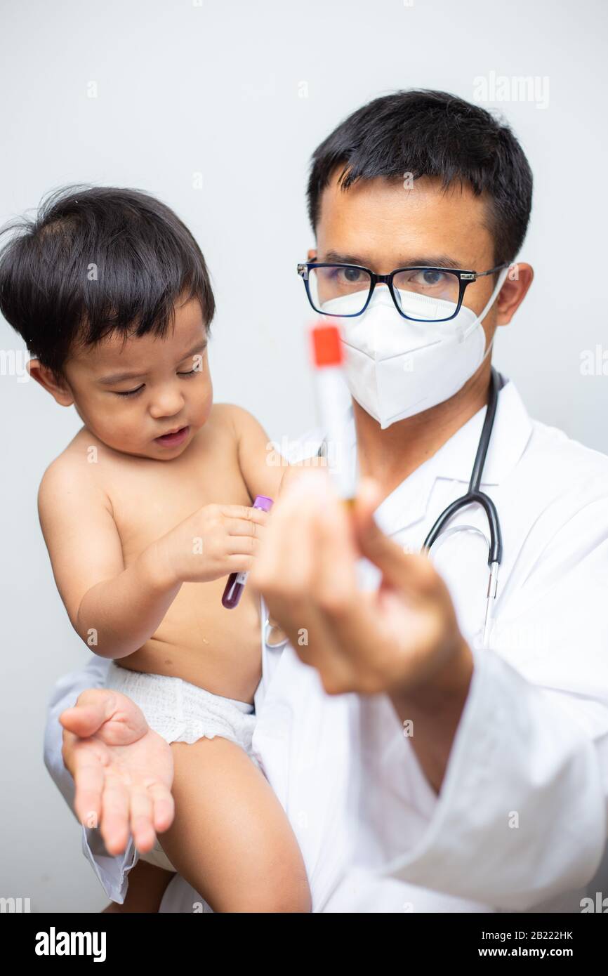 Doctor holding asian baby boy with Coronavirus (COVID-19) Blood in ...