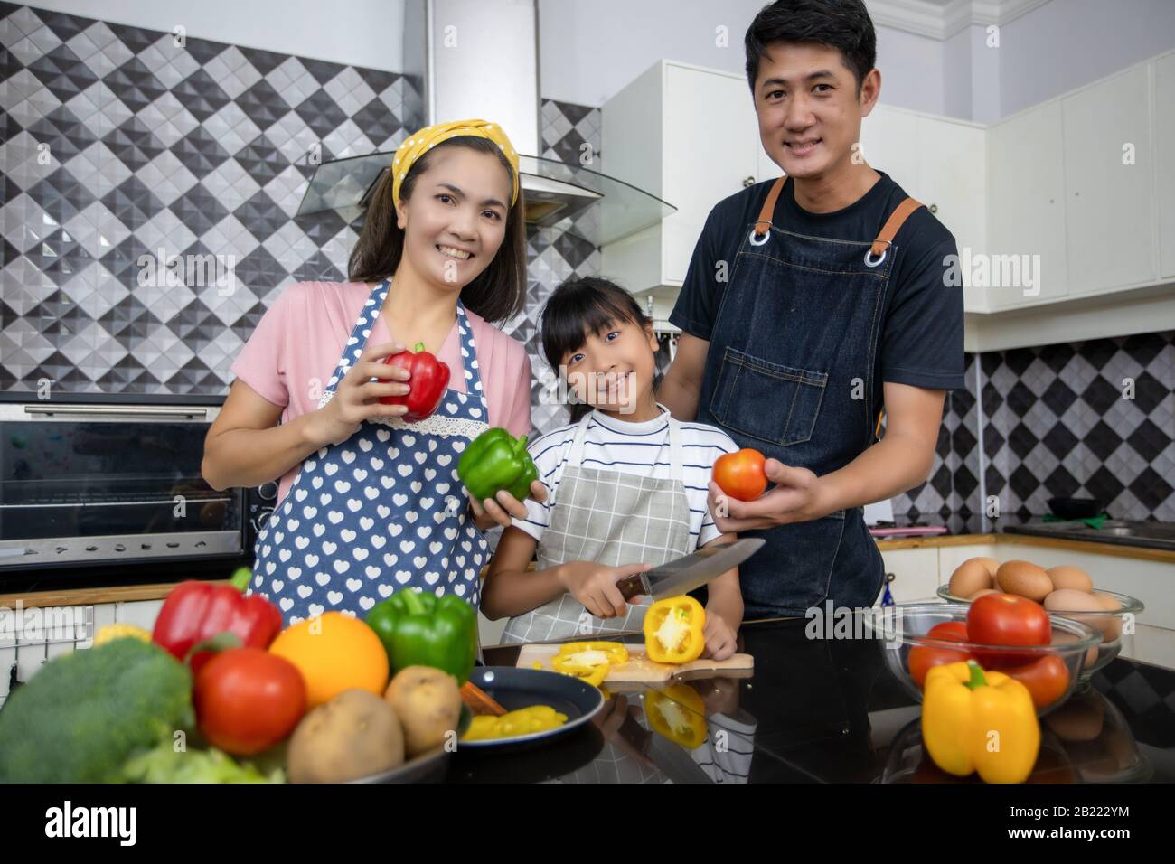 Happy Family have Dad, Mom and their little daughter Cooking Together ...