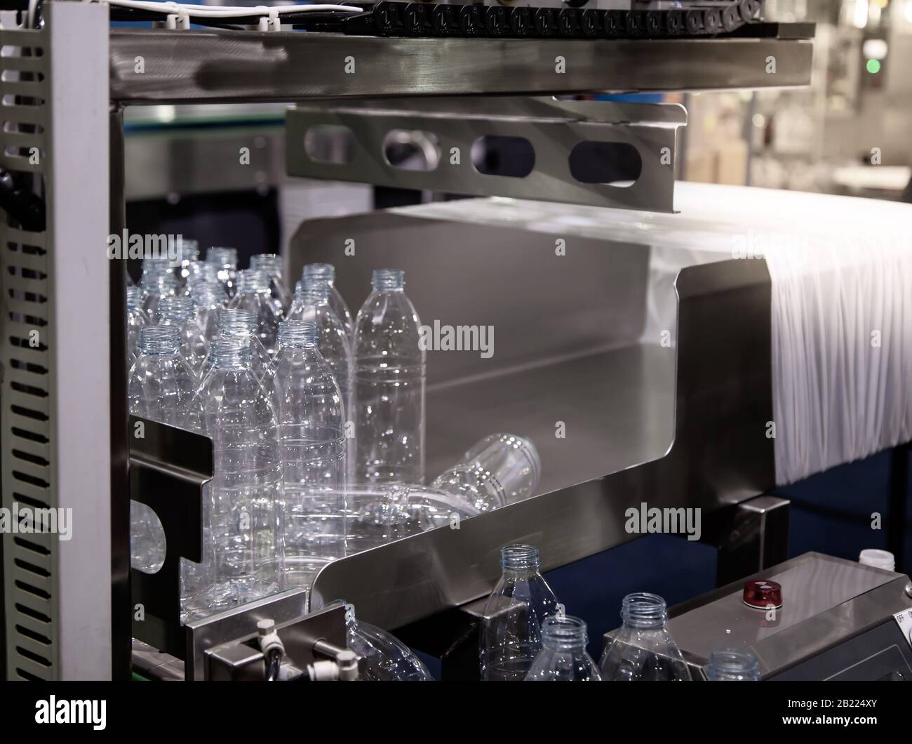 Production line collecting empty plastic bottle from blowing machine ...