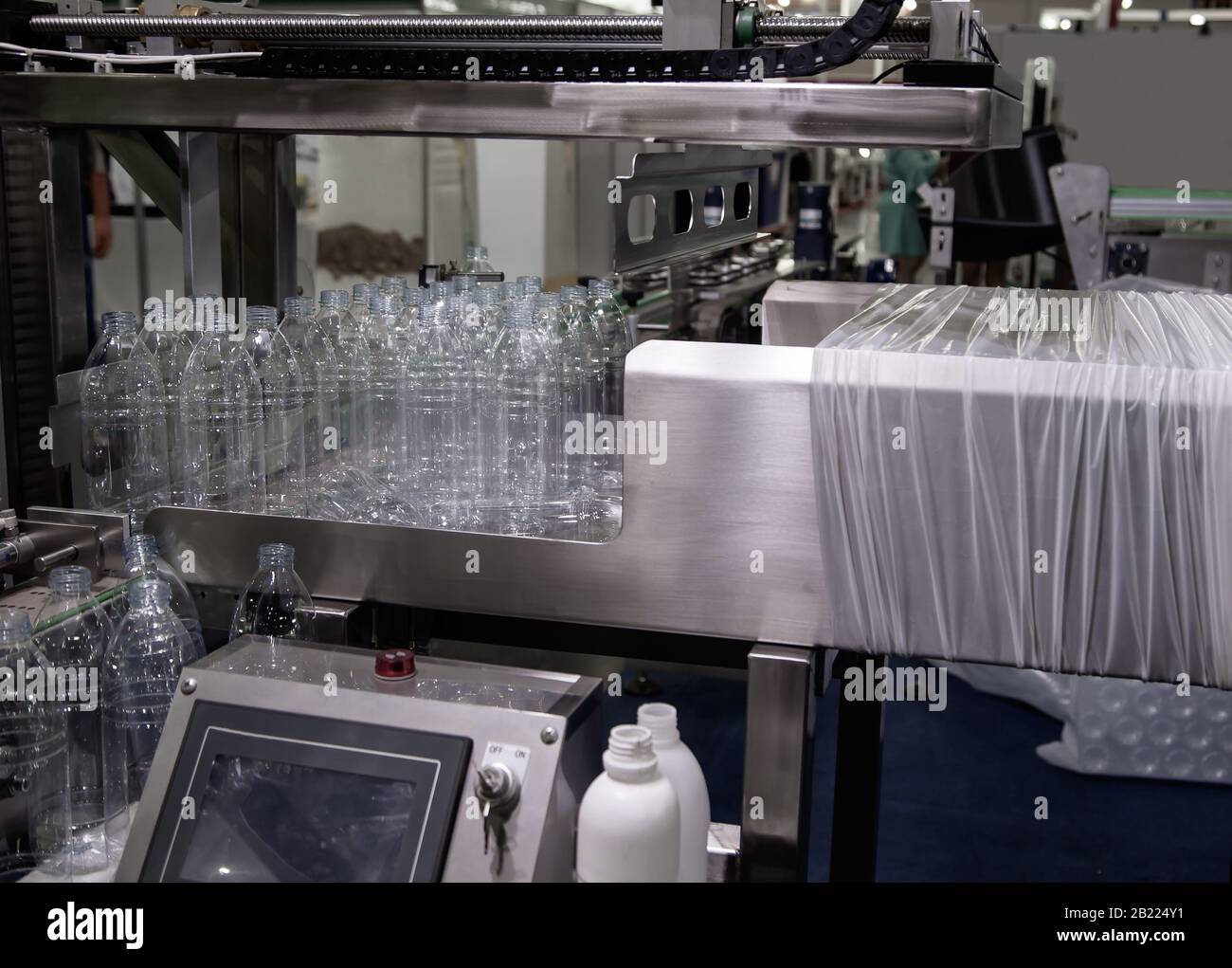 Production line collecting empty plastic bottle from blowing machine ...