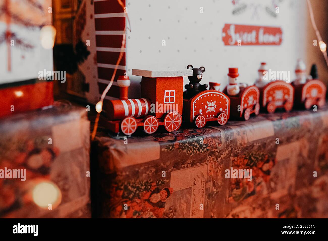 red long wooden train toy in garlands Stock Photo - Alamy