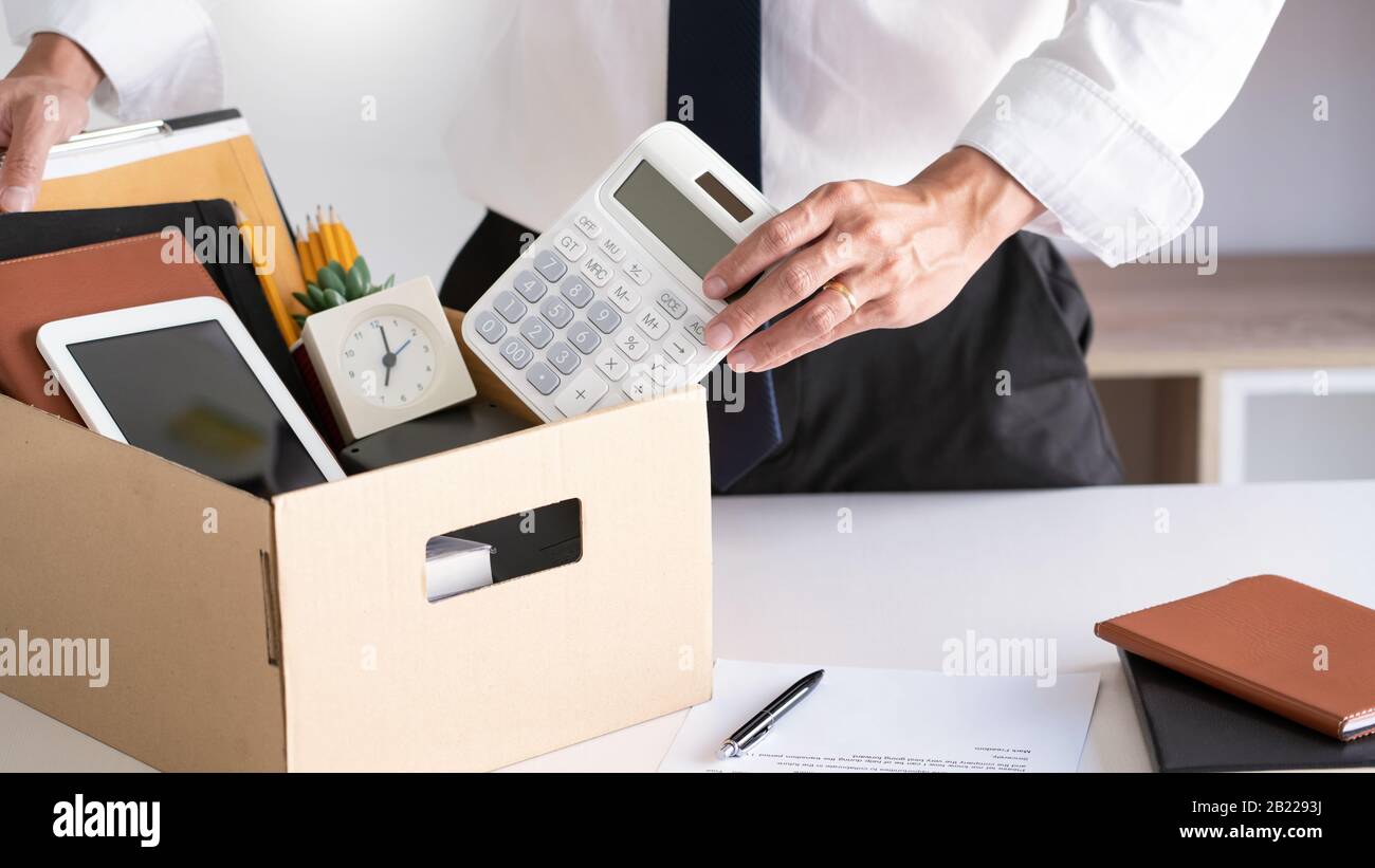Businessmen are holding resignation document and packing personal ...