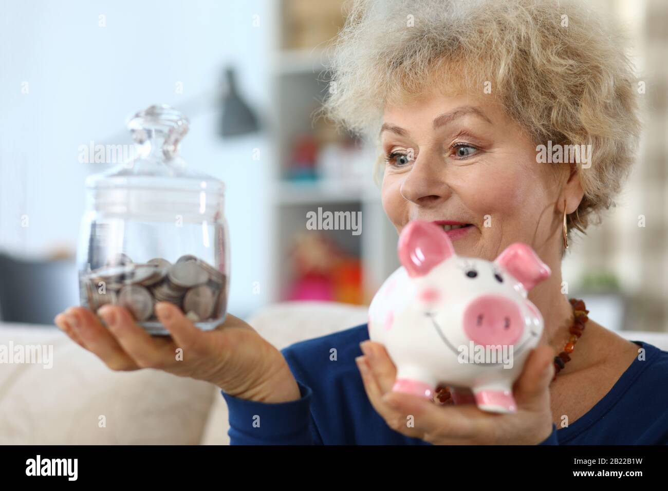 Old lady holding coins hi-res stock photography and images - Alamy