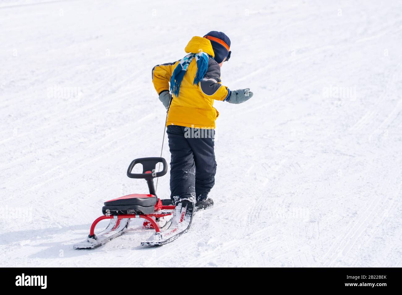 Child pulling sled up hill hi-res stock photography and images - Alamy