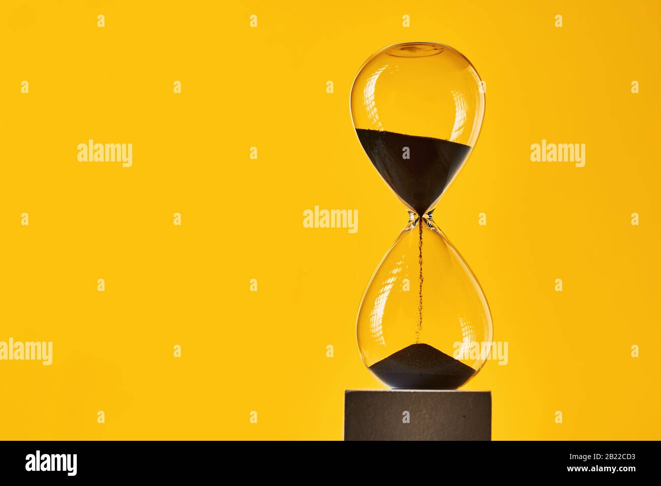 Hourglass on yellow background with copy space. Concept of running out ...