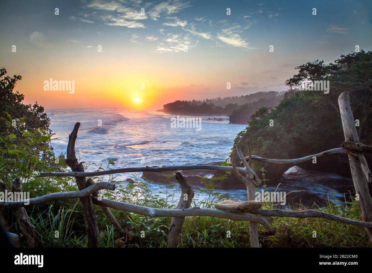 scenic elevated panoramic view of sunset over ocean and rock arch in ...