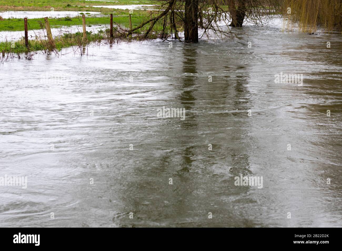 Flooded river after heavy storm rainfall flooding adjacent farmland ...