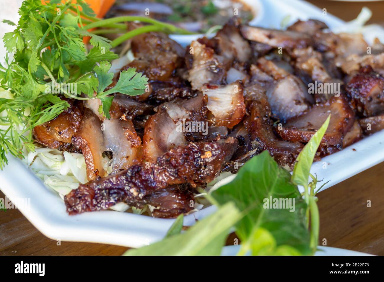 Thai grilled wild boar pork dish Stock Photo - Alamy