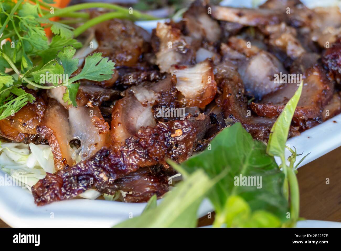 Thai grilled wild boar pork dish Stock Photo - Alamy
