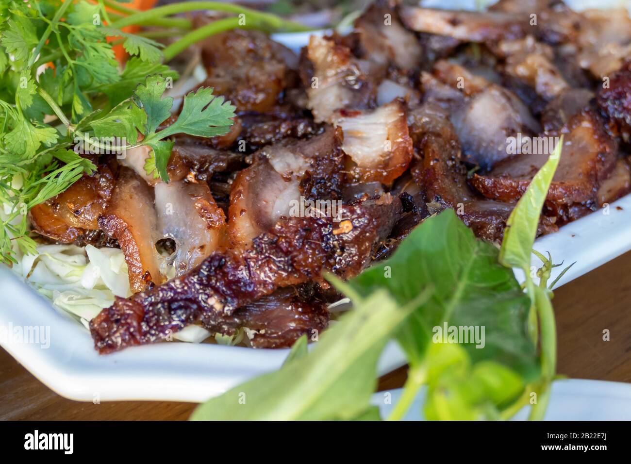 Thai grilled wild boar pork dish Stock Photo - Alamy