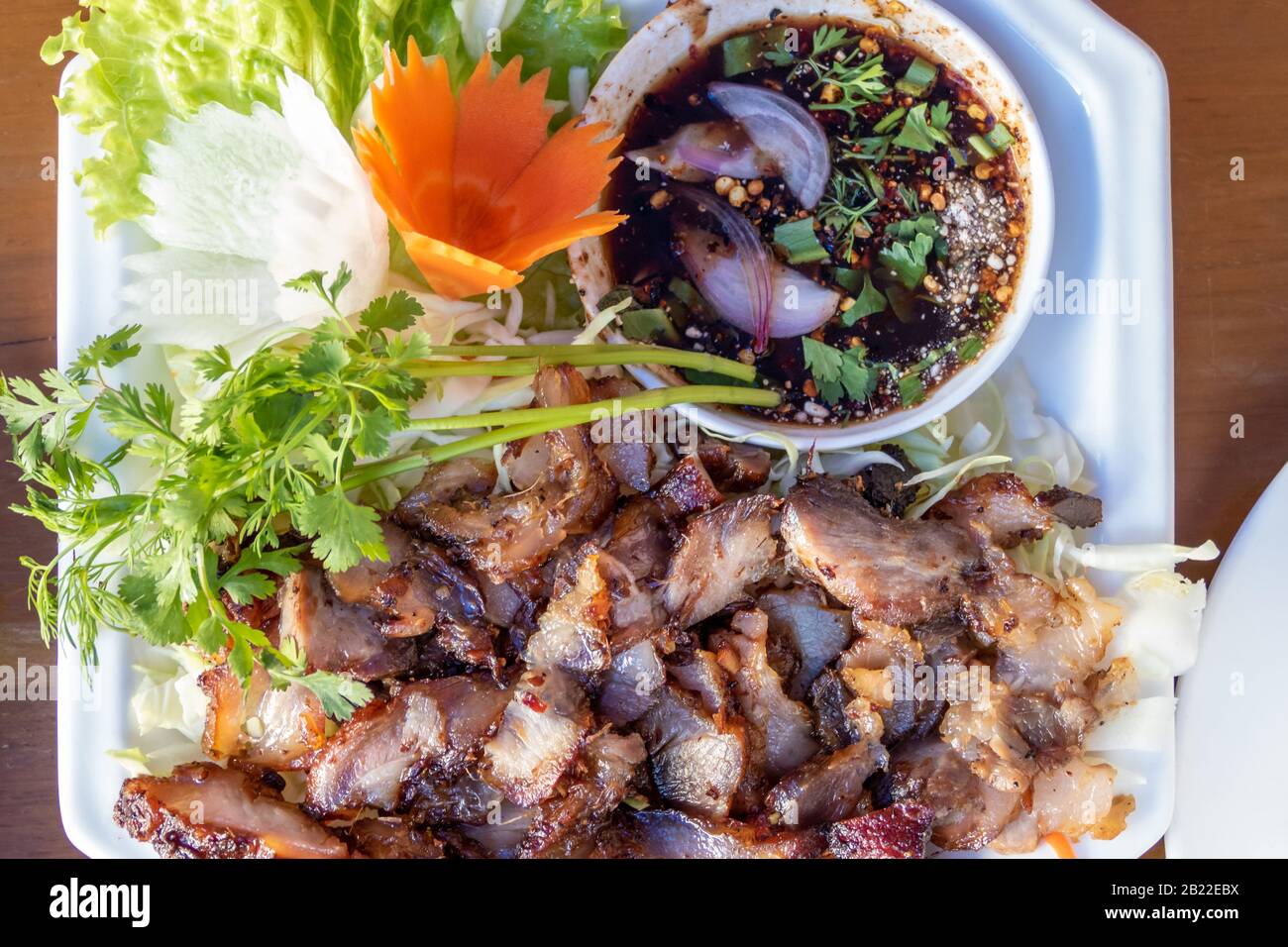 Thai grilled wild boar pork dish Stock Photo - Alamy