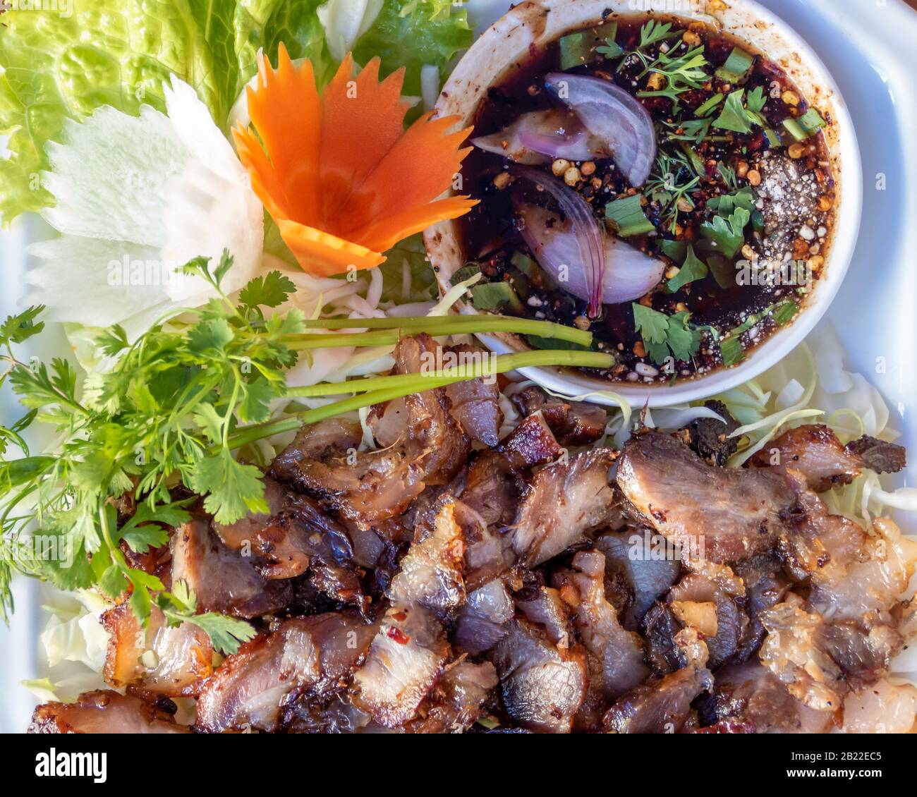 Thai grilled wild boar pork dish Stock Photo - Alamy