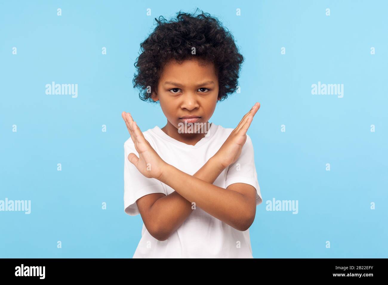 Stop, I'm warning. Portrait of angry determined little boy with curls ...