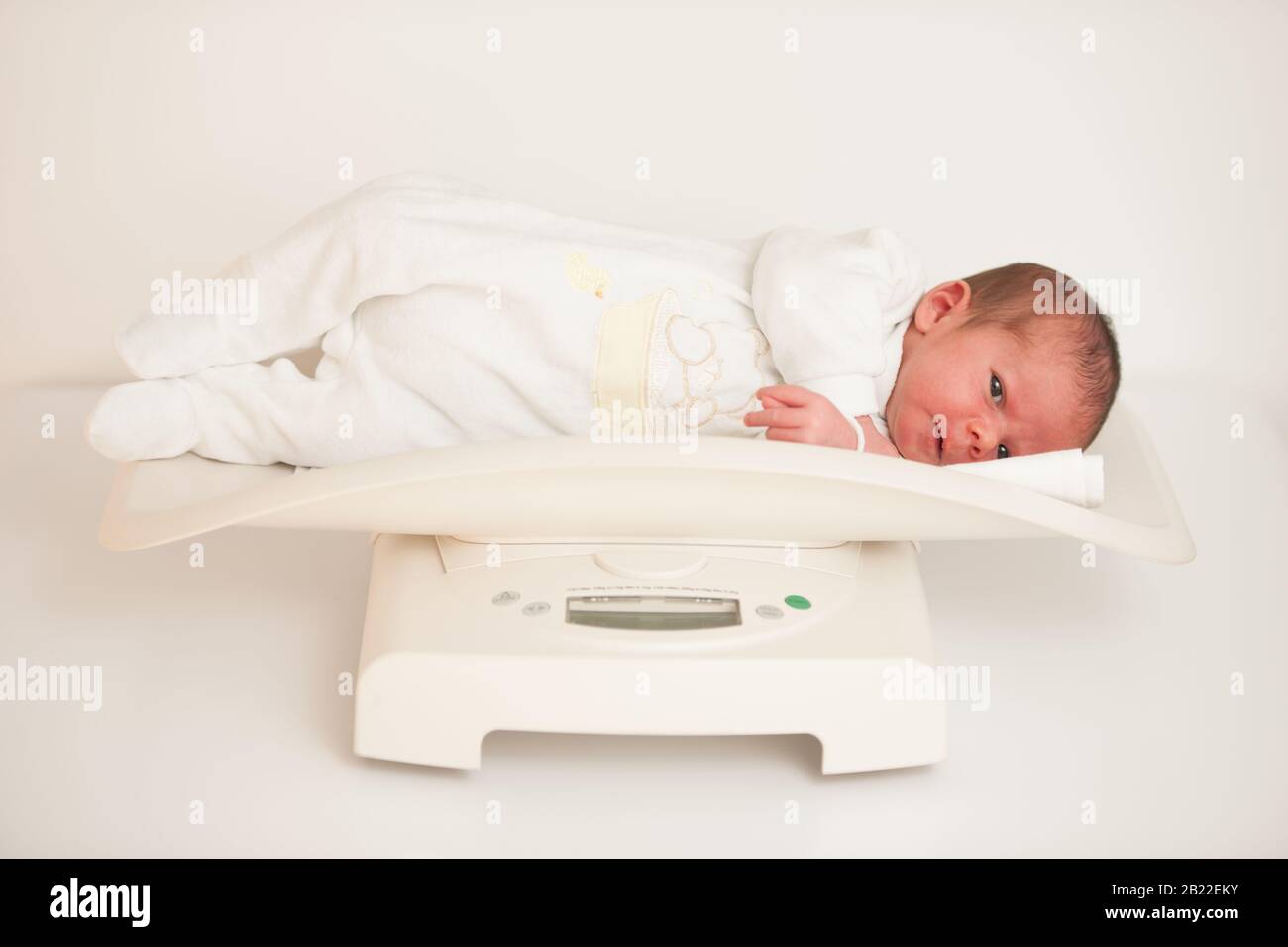 Weighing baby on the scale hi-res stock photography and images - Alamy