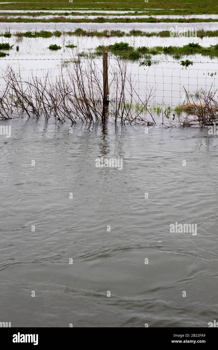 Flooded river after heavy storm rainfall flooding adjacent farmland ...