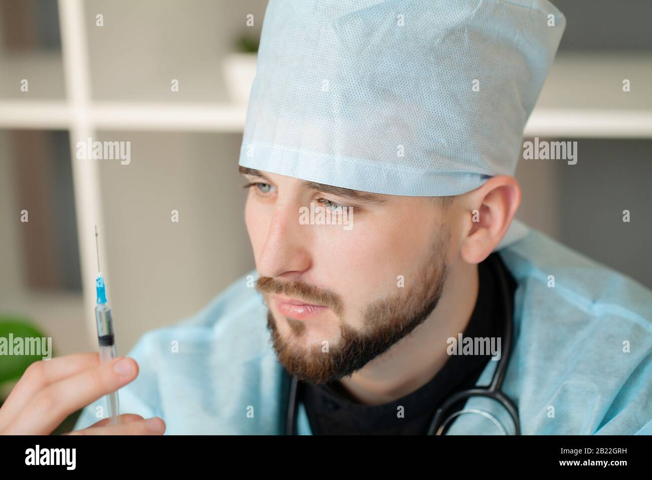Doctor holding medical injection syringe in clinic Stock Photo - Alamy