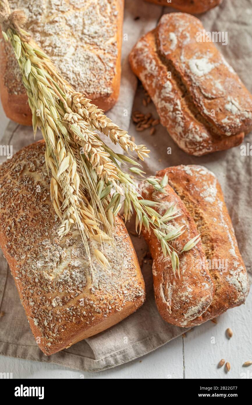 Rustic buns with ears and grains of wheat Stock Photo - Alamy