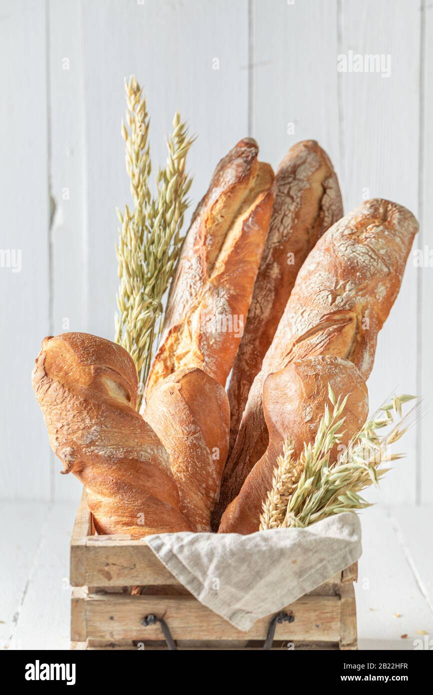 Homemade golden baguettes freshly baked in wooden box Stock Photo - Alamy