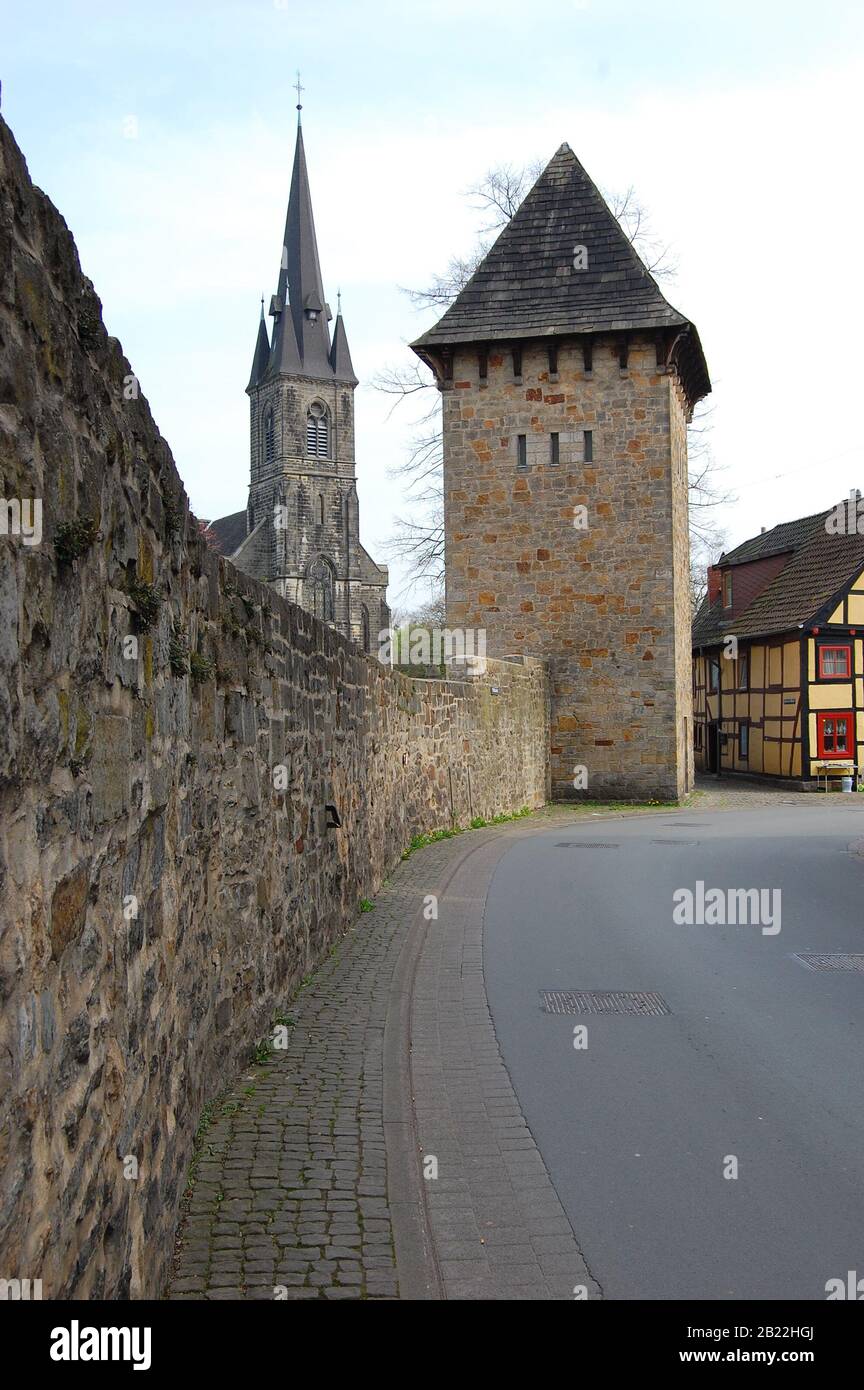 Old City wall with watch tower and tower of a church in Rinteln Stock ...