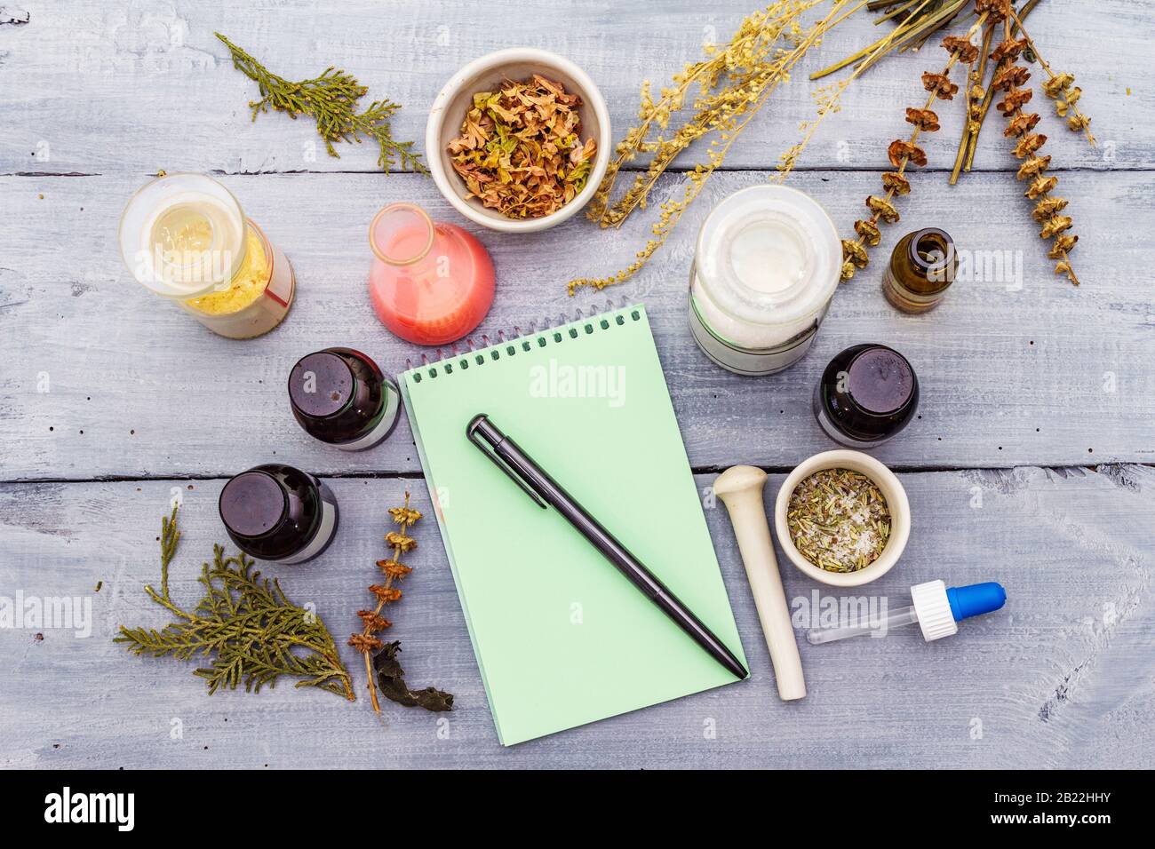 Notebook surrounded by herbs, alchemy appliances, potions and vintage ...