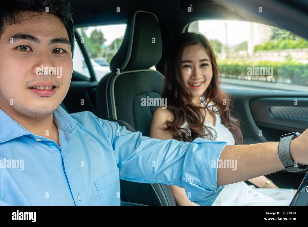 Asian Couple are driving in a car for test drive before buy new car ...
