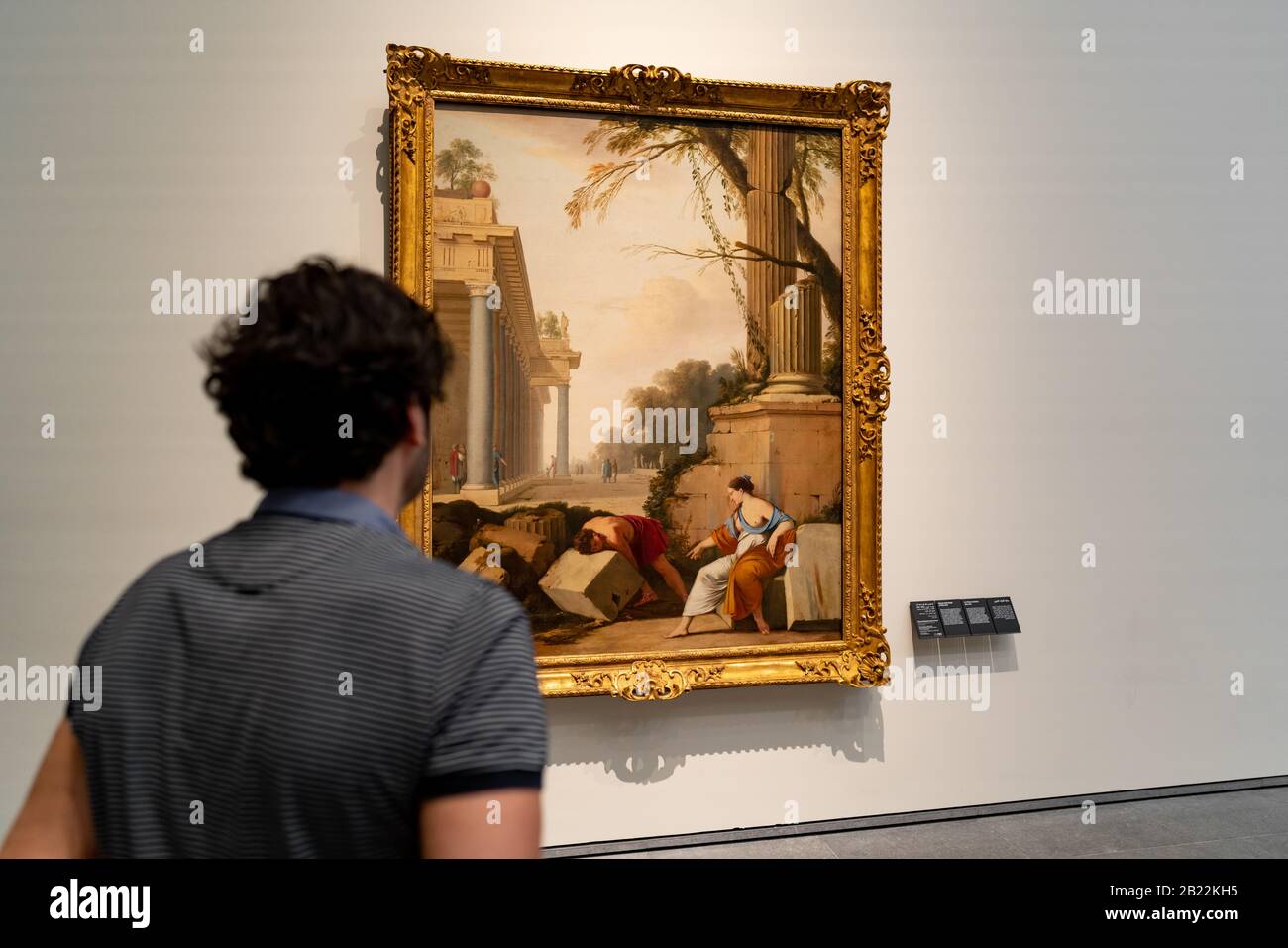 Young man admiring art at a museum | Detail of ancient Roman paintings ...