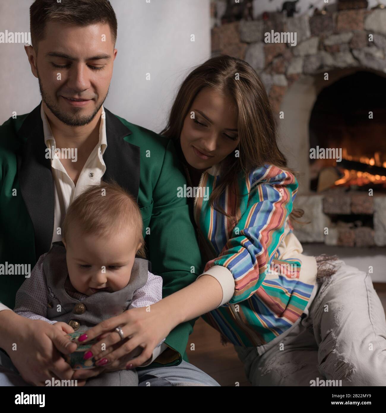 Young happy family together in interior of wooden house Stock Photo - Alamy