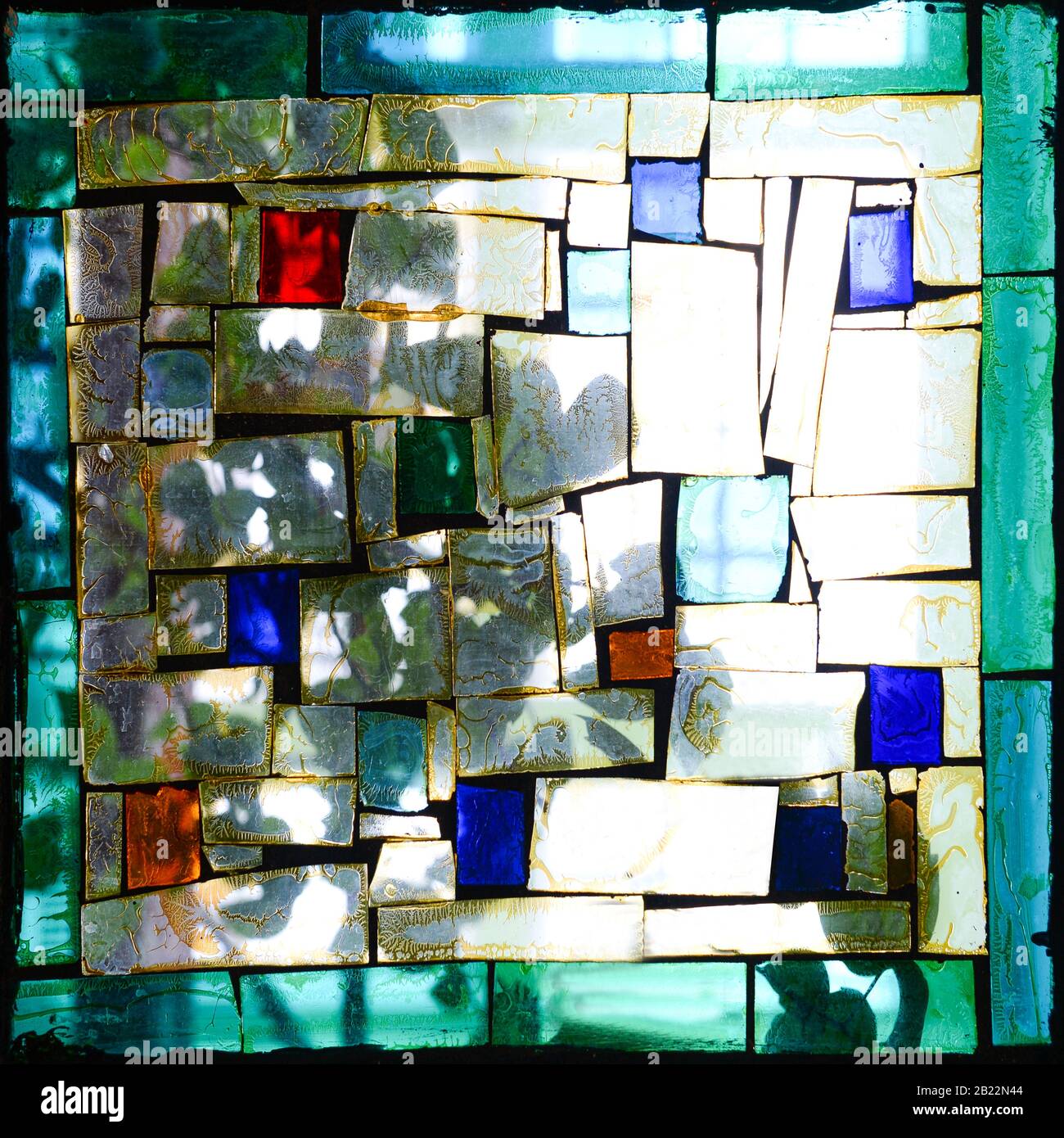 Image of a multi-colored stained-glass window with a block pattern ...