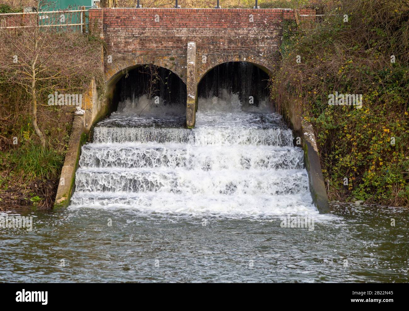 Bridge and weir with rushing water on River Marden, Bremhill, Calne ...