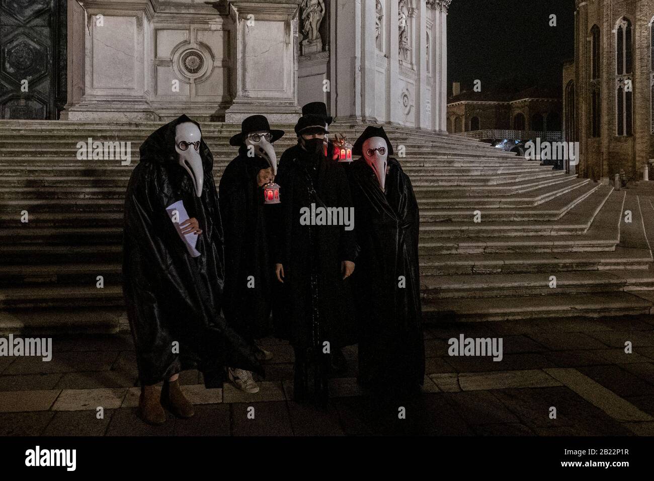 VENICE, ITALY - FEBRUARY 25: Plague doctors pose in Venice on February ...