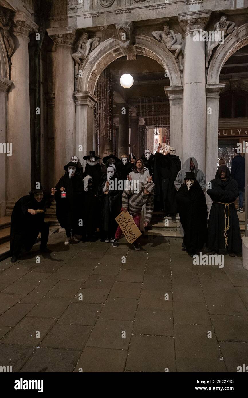 VENICE, ITALY - FEBRUARY 25: Plague doctors pose in Venice on February ...