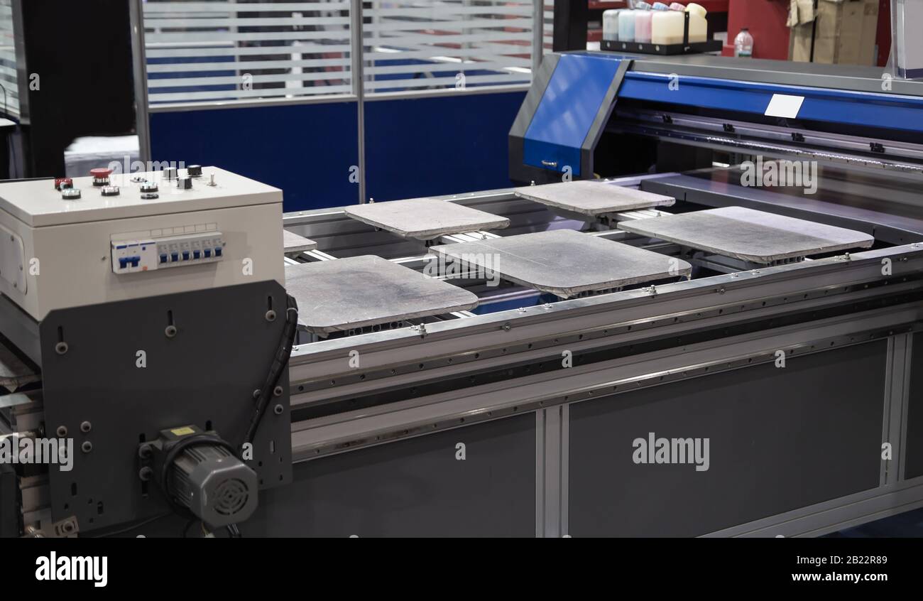 T-shirt digital printing machine in garment industry Stock Photo - Alamy