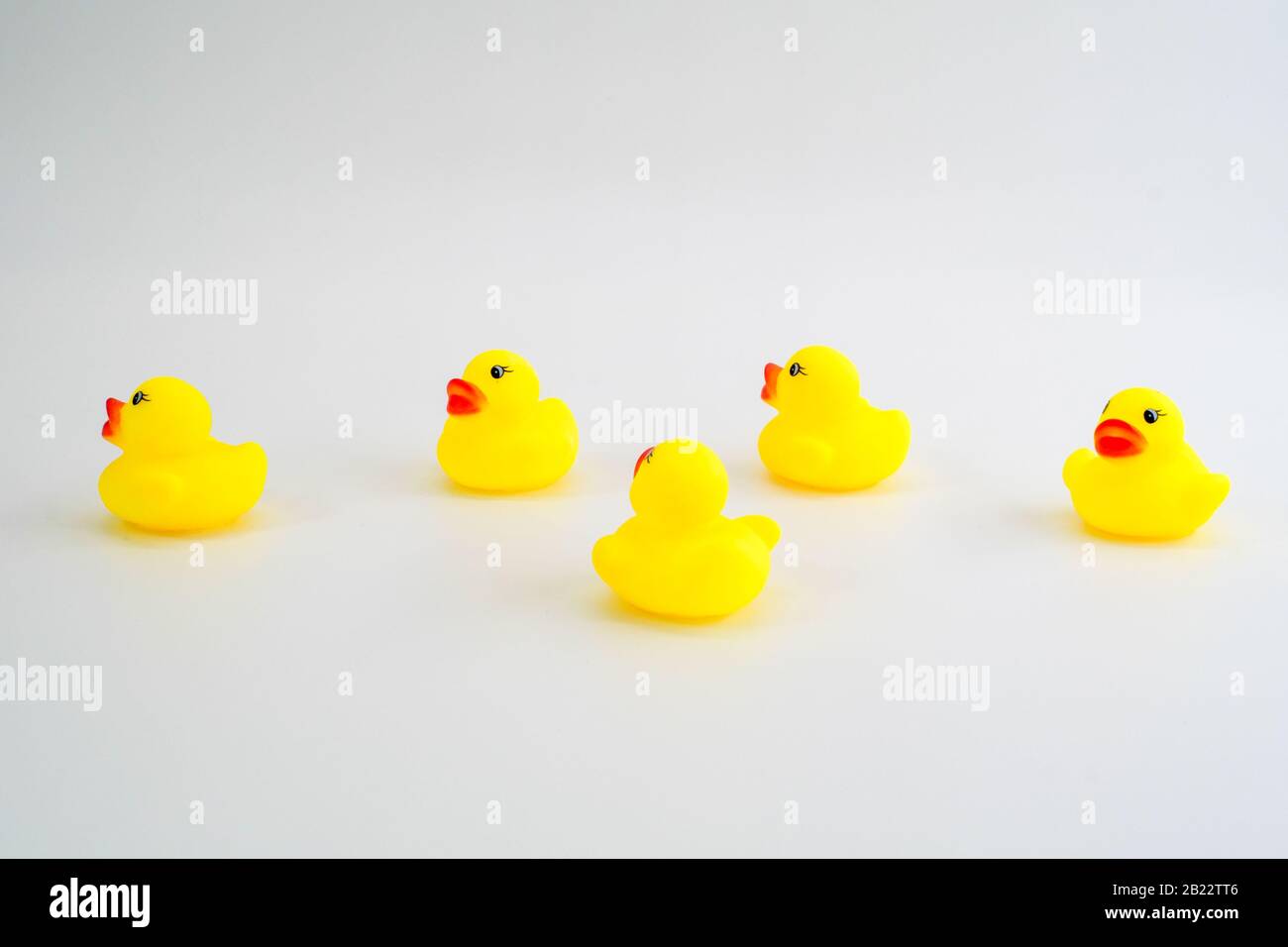 Five mini yellow rubber ducks in a random placed group. Getting your ...