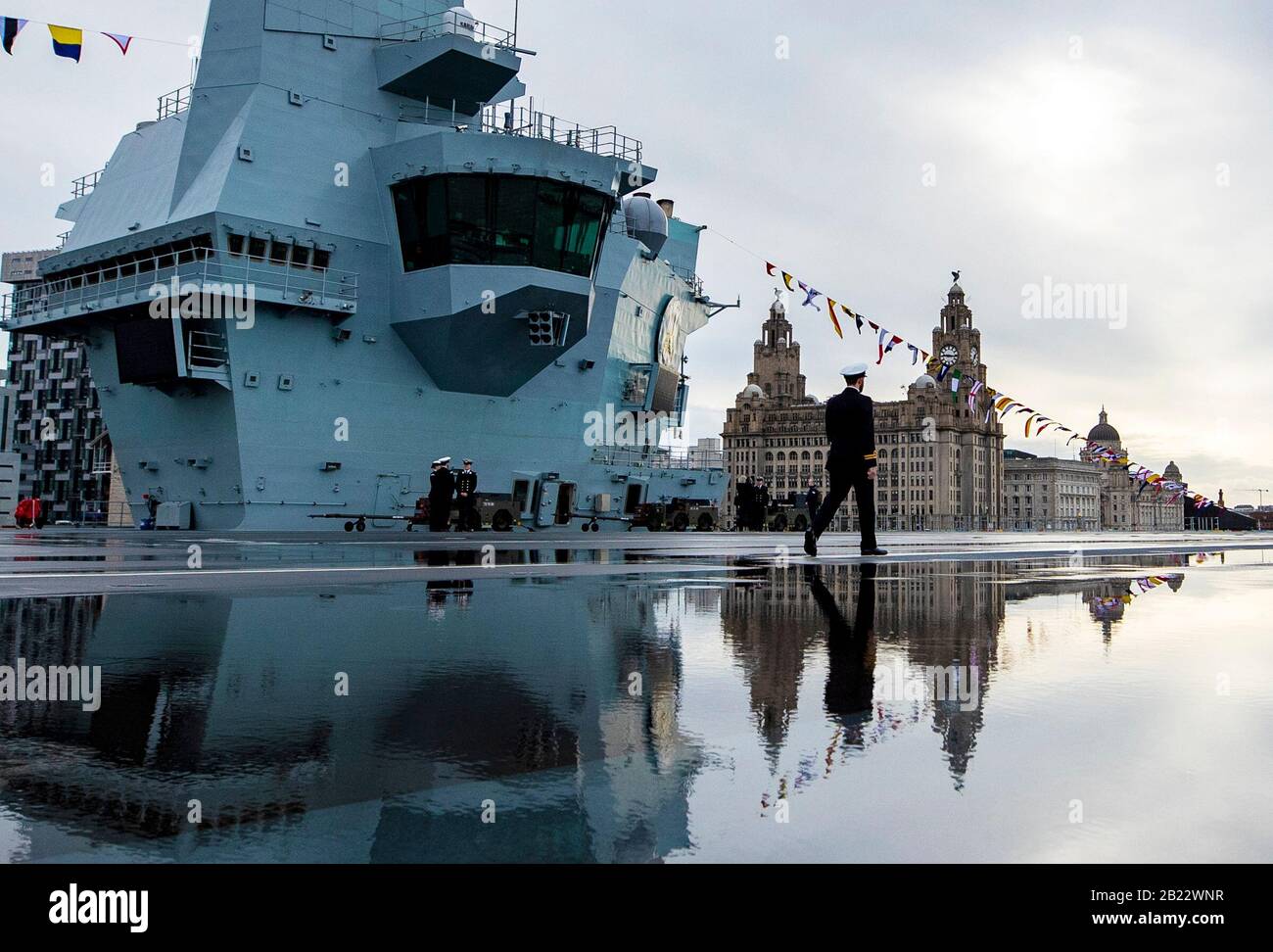 The Royal Navy aircraft carrier HMS Prince of Wales sits in front of ...