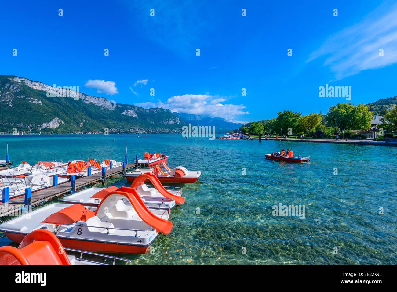 Pedal boats on Lake Annecy, one of the largest lakes in France known as ...