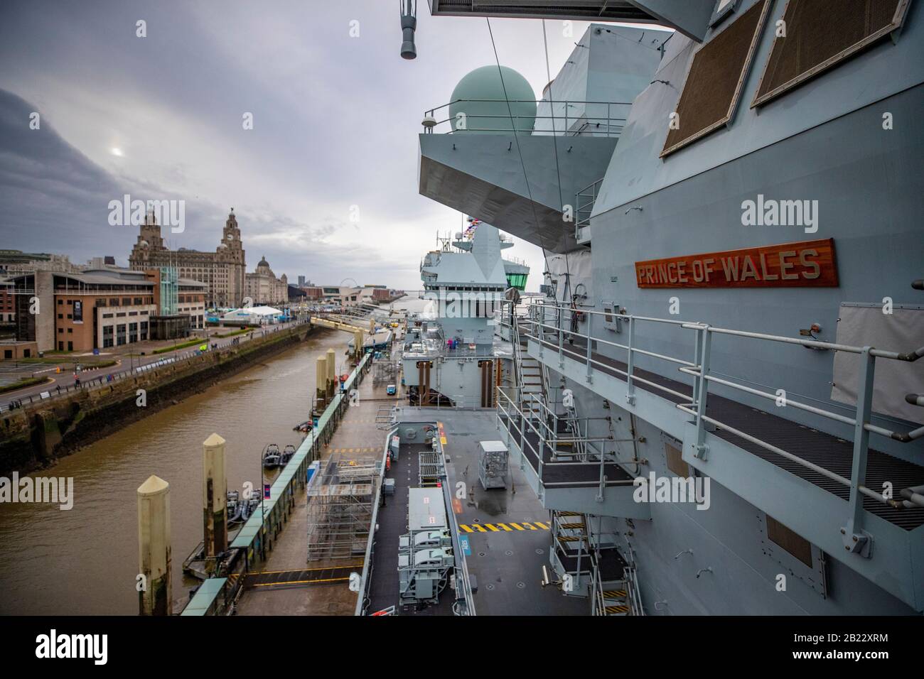 The Royal Navy aircraft carrier HMS Prince of Wales sits in front of ...