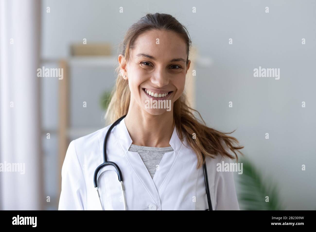 Head shot portrait smiling mixed race female doctor in uniform Stock ...