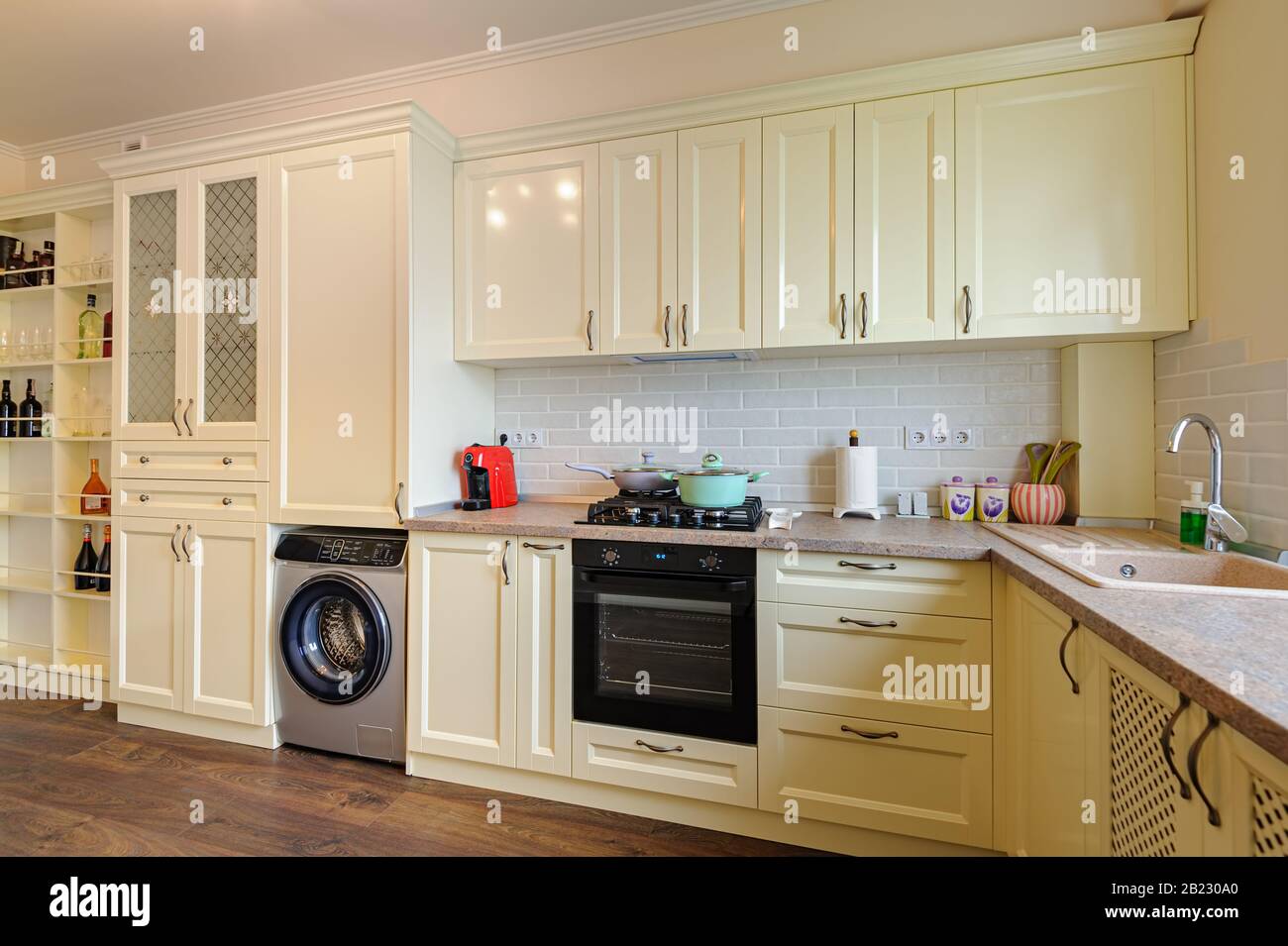modern cream colored kitchen interior Stock Photo - Alamy