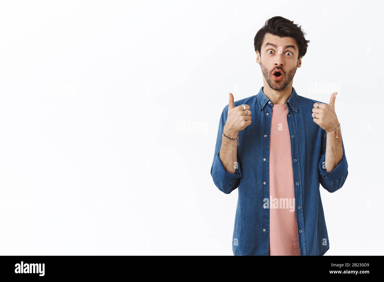 Surprised and impressed handsome man leaving positive feedback as ...