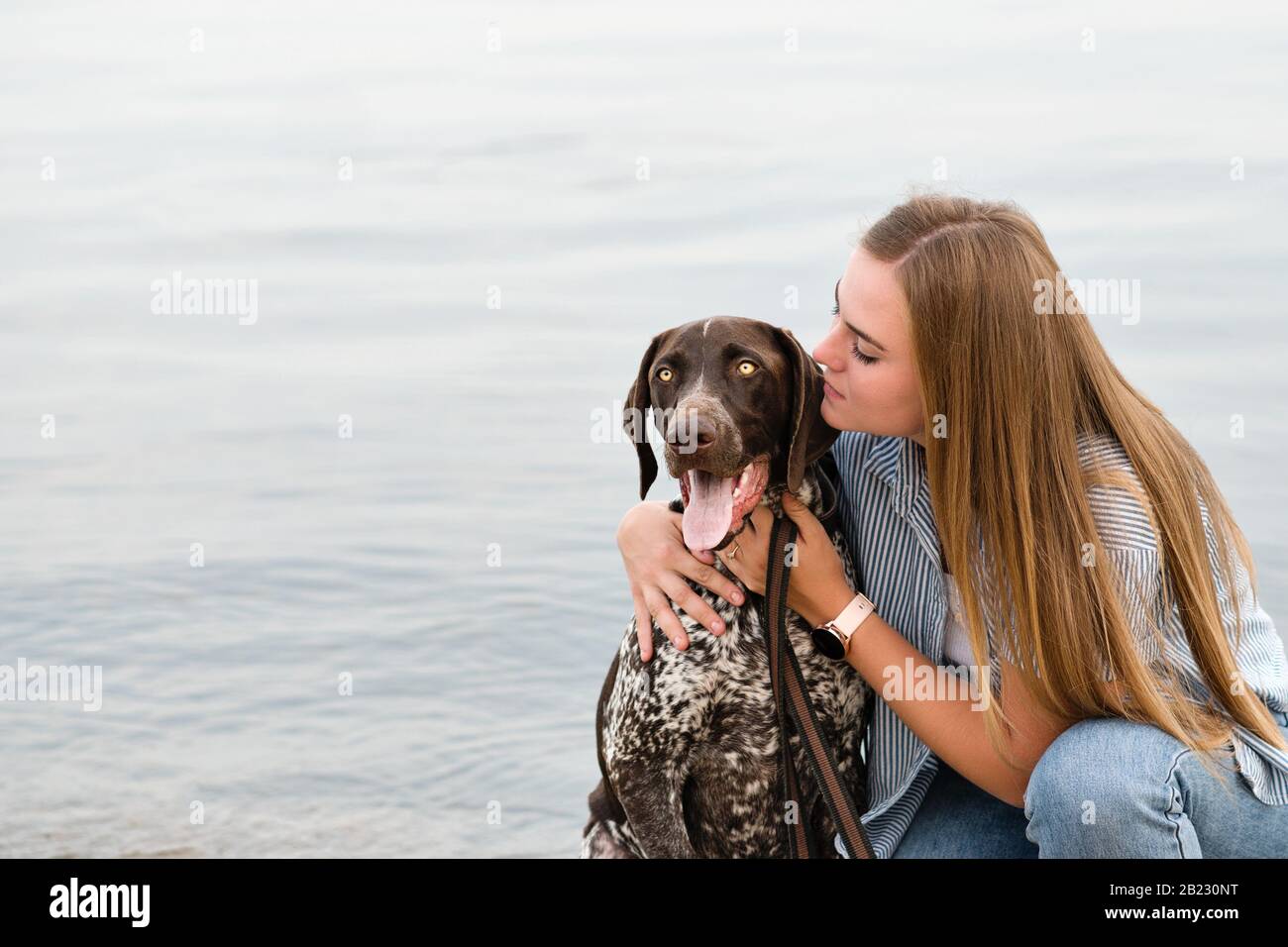 Best friends young woman and German Shorthaired Pointer sitting on by ...