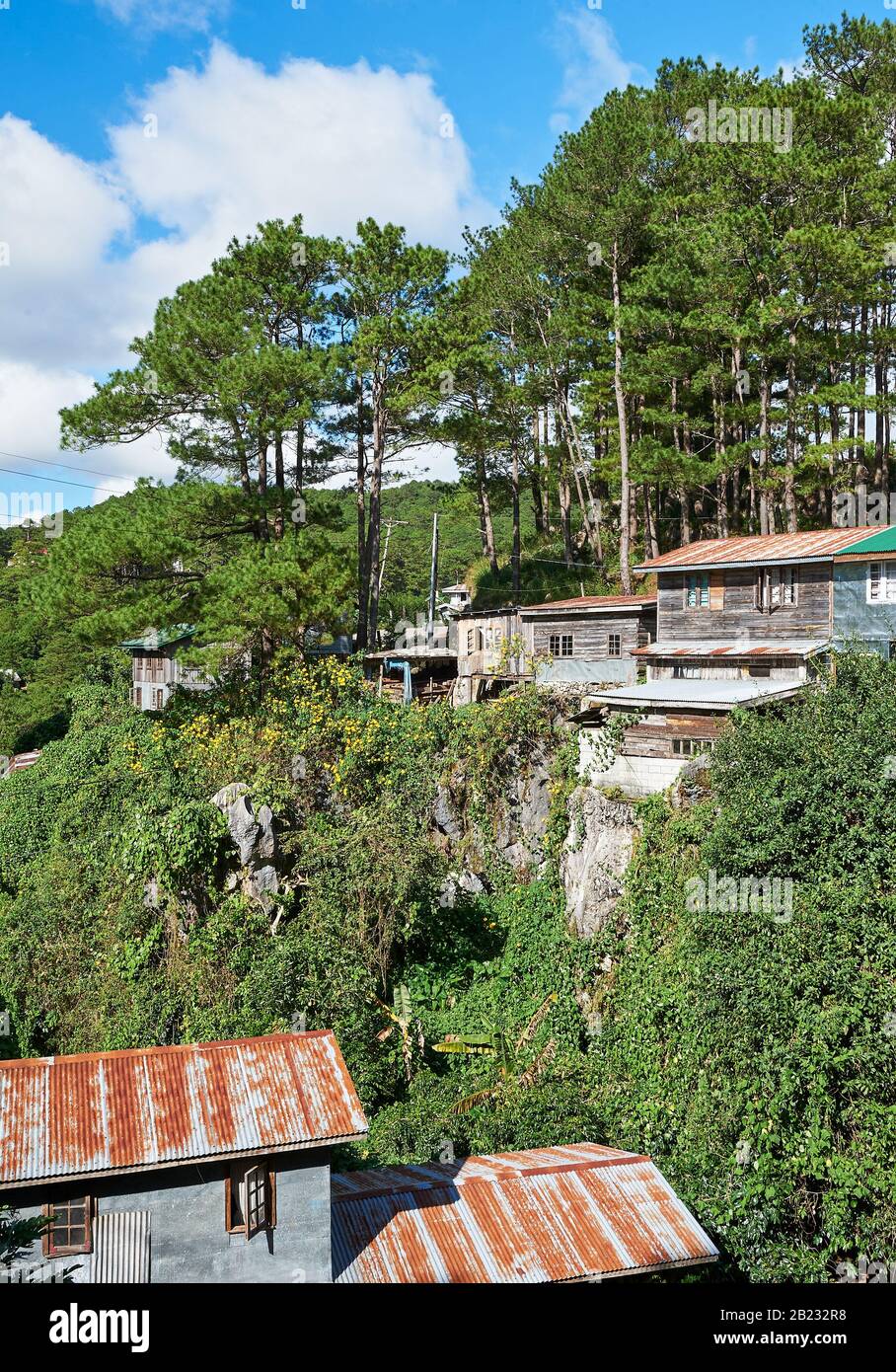 Traditional wooden houses with rusty metal roofs, built on top of lime ...