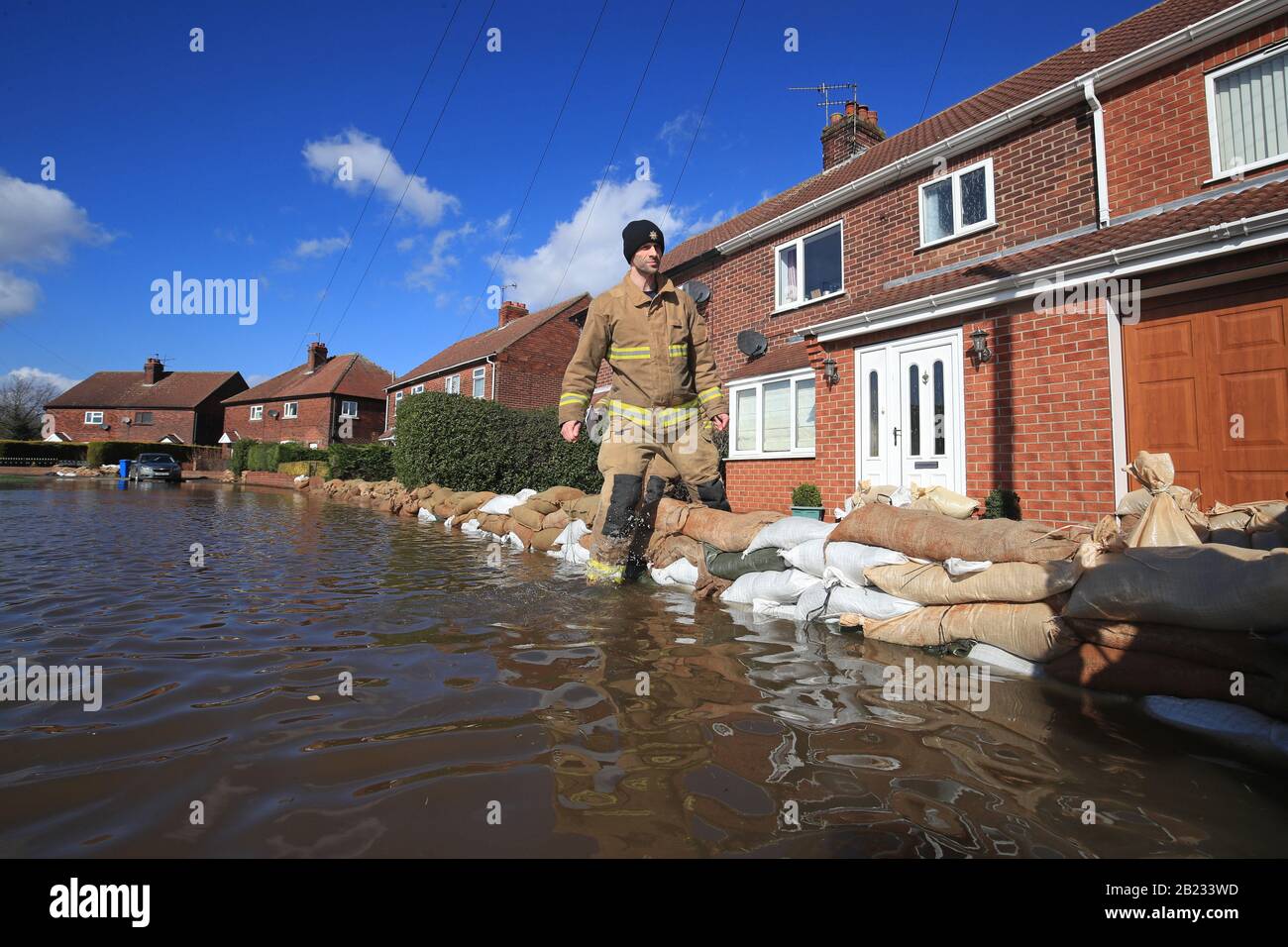 Fire fighters help with sand bags in the flooded town of East Cowick ...